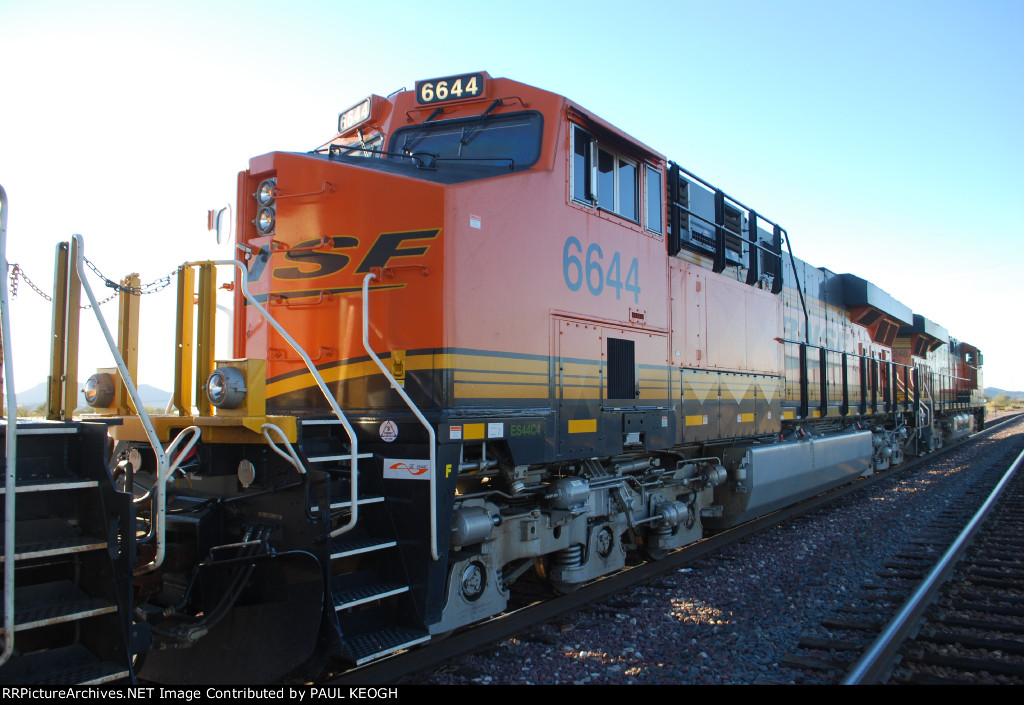BNSF 6644 reflects the rays of sun in this shadow shot as she waits to roll north to Ash Fork ...